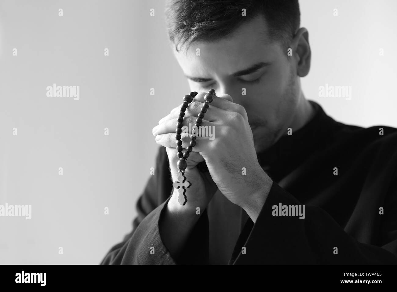 Rosary beads and priest Black and White Stock Photos & Images - Alamy