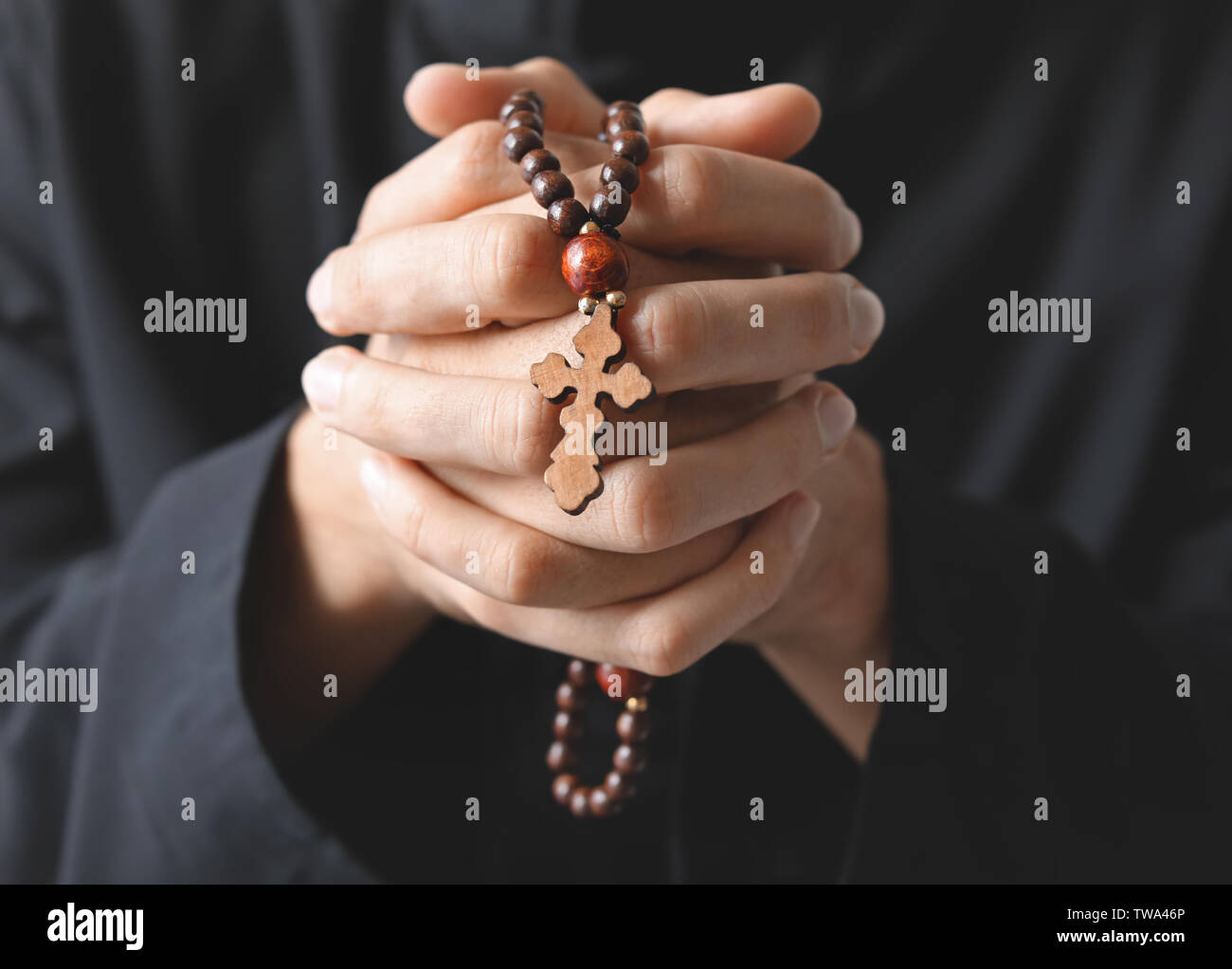 Young priest with rosary beads, closeup Stock Photo - Alamy
