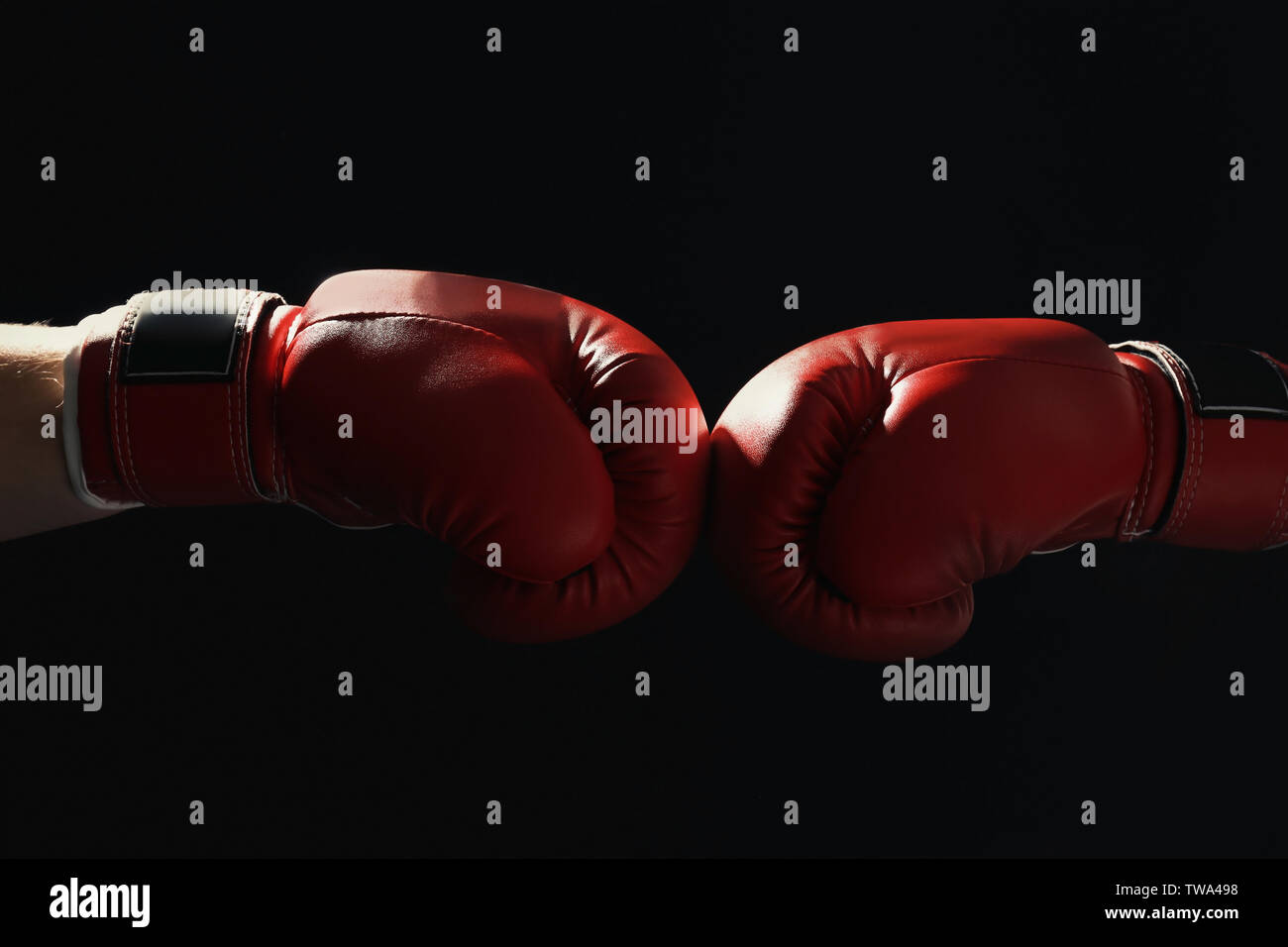 Men in boxing gloves on black background Stock Photo - Alamy