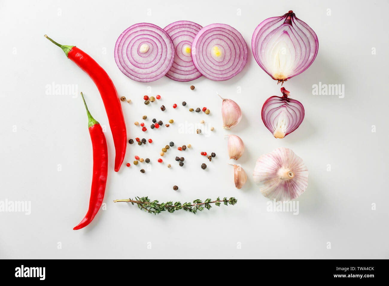 Red onion, garlic, thyme and chili peppers on white background Stock ...