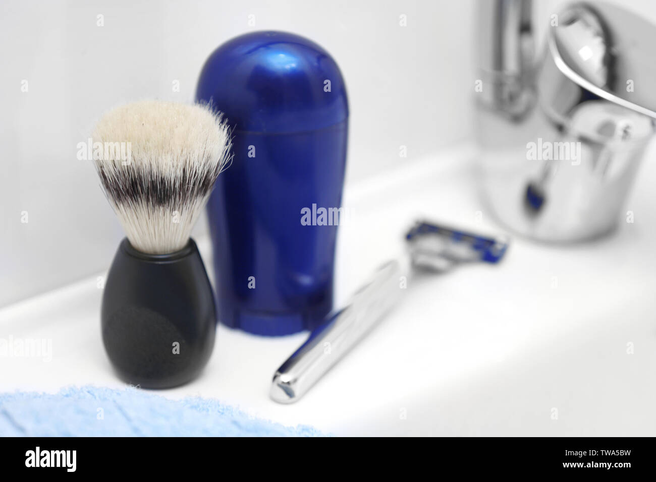 Shaving brush, deodorant and razor for man on sink Stock Photo - Alamy