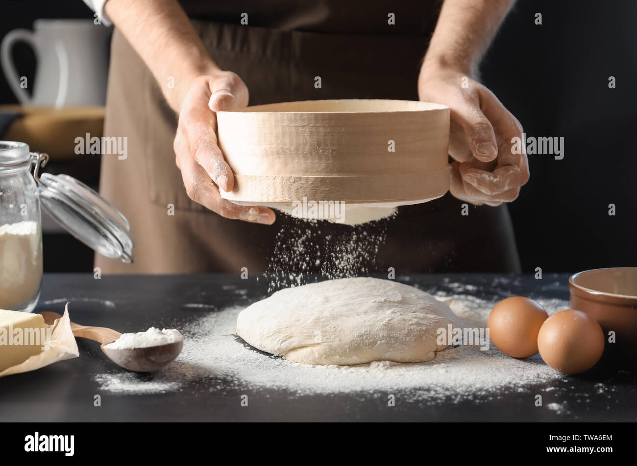 Male baker sifting flour hi-res stock photography and images - Alamy