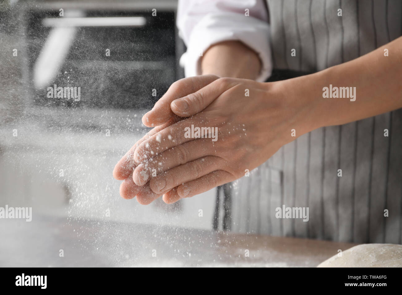 Cook clapping hands flour splash hi-res stock photography and images ...