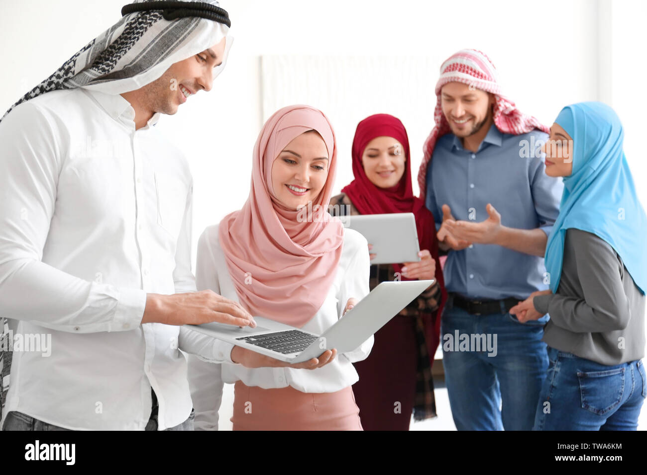Muslim office employees in traditional clothes having business meeting ...