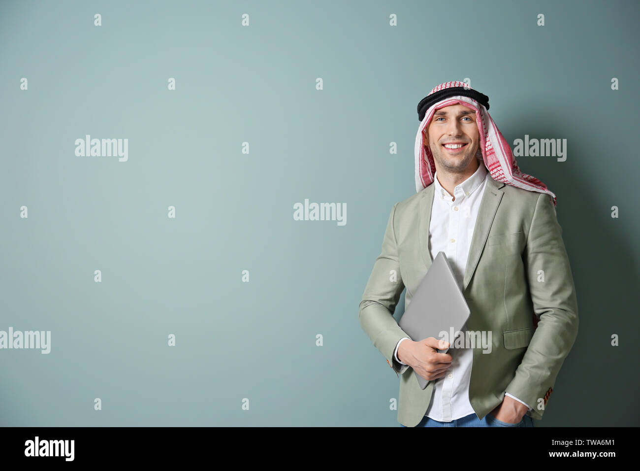 Muslim businessman in traditional clothes on color background Stock ...