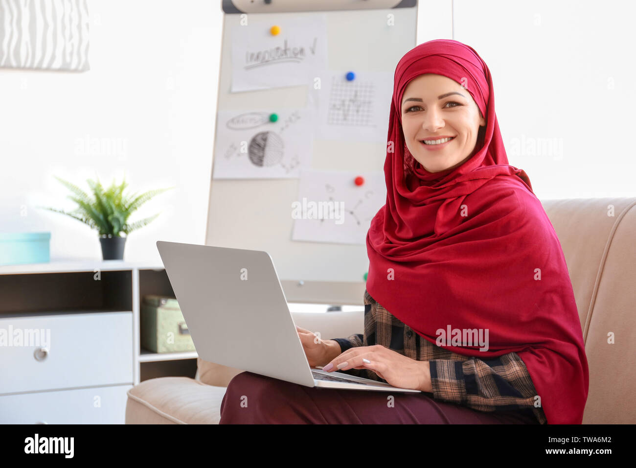 Muslim businesswoman in traditional clothes at workplace Stock Photo ...