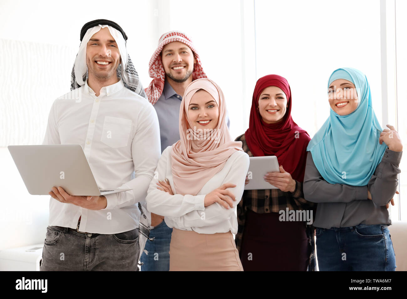 Muslim office employees in traditional clothes having business meeting ...