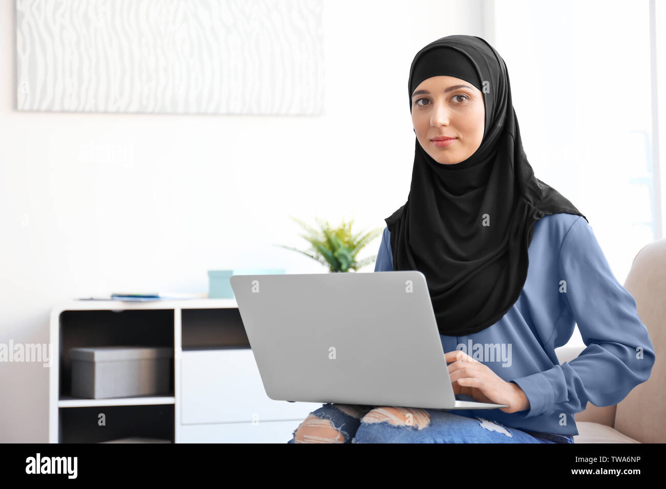 Muslim businesswoman in traditional clothes at workplace Stock Photo ...
