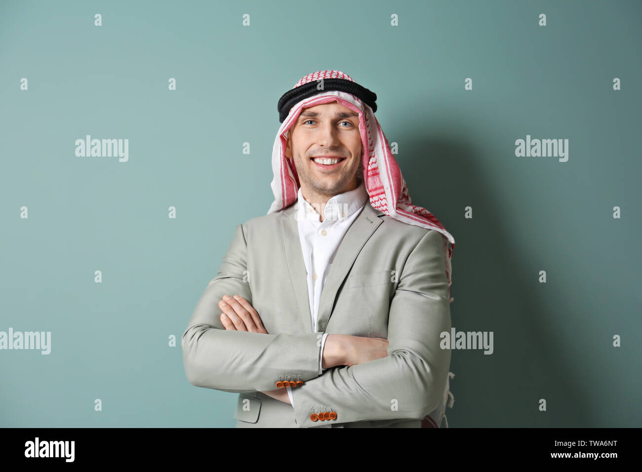 Muslim businessman in traditional clothes on color background Stock ...