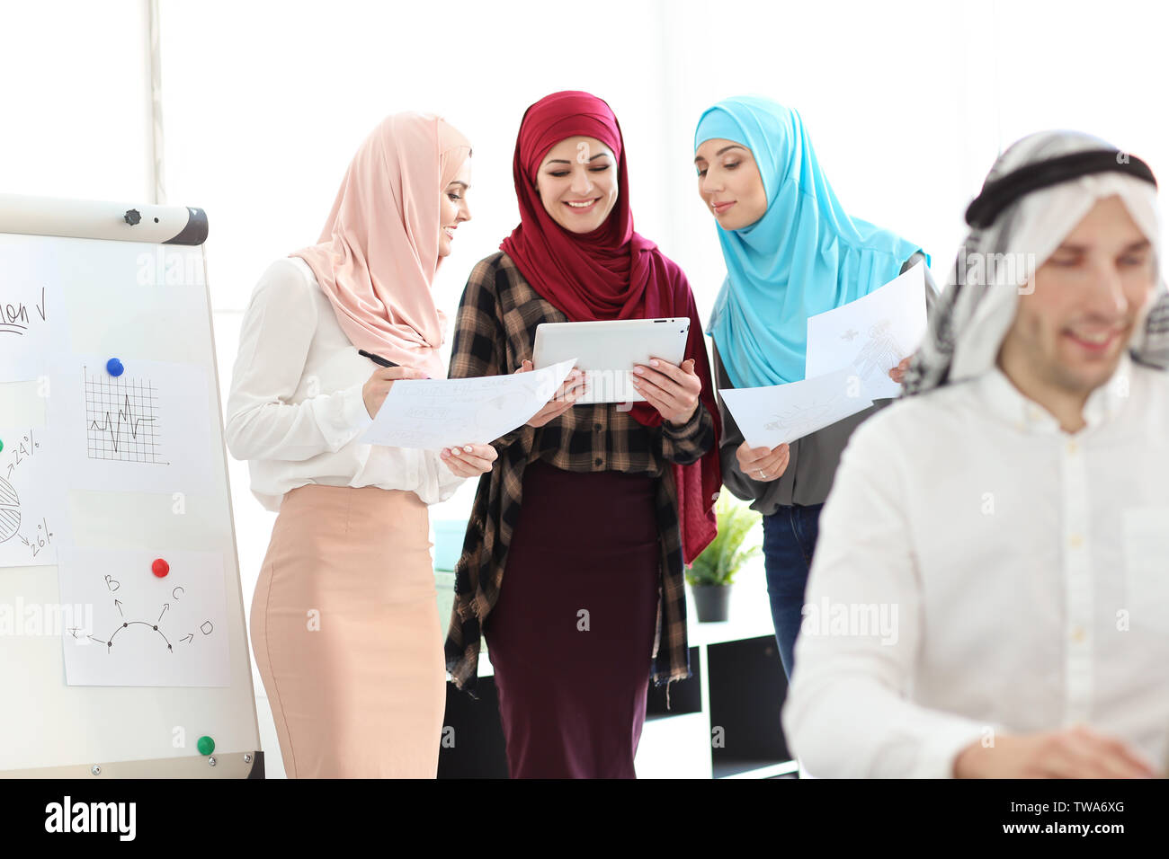 Muslim businesswomen in traditional clothes at workplace Stock Photo ...
