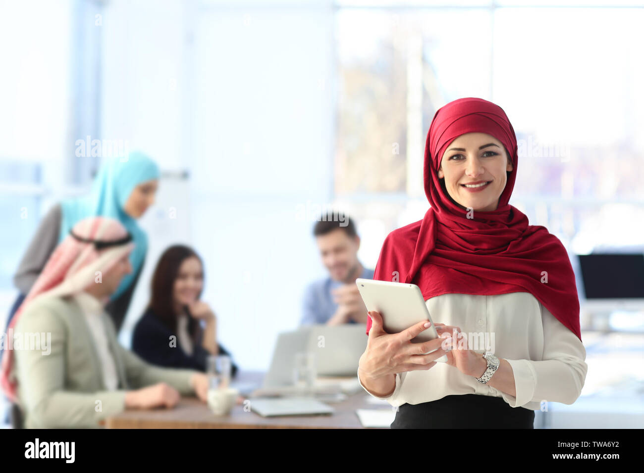 Muslim businesswoman in traditional clothes at workplace Stock Photo ...