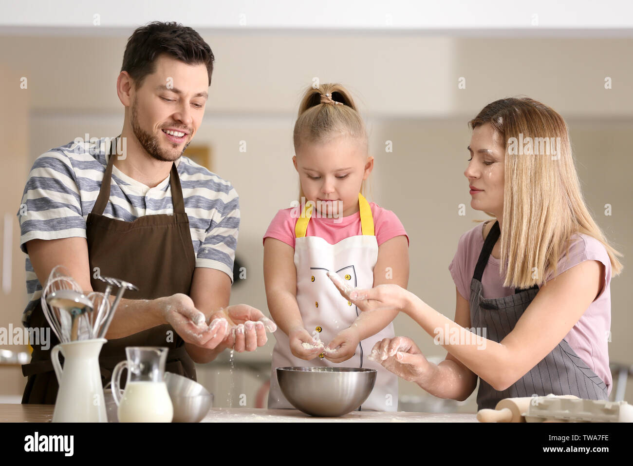 Happy family with flour in kitchen Stock Photo - Alamy