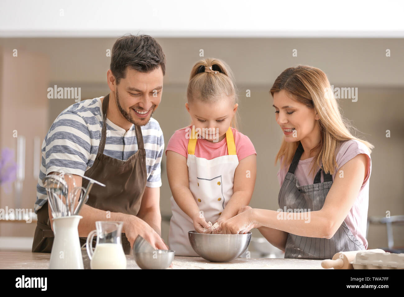 Happy family with flour together in kitchen Stock Photo - Alamy