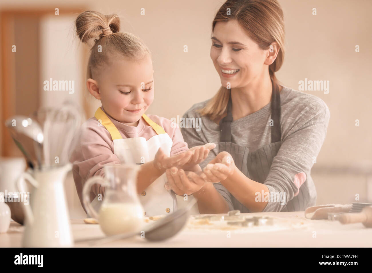 Mother and daughter having fun with flour in kitchen Stock Photo - Alamy