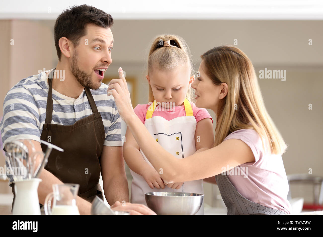 Happy family with flour together in kitchen Stock Photo - Alamy