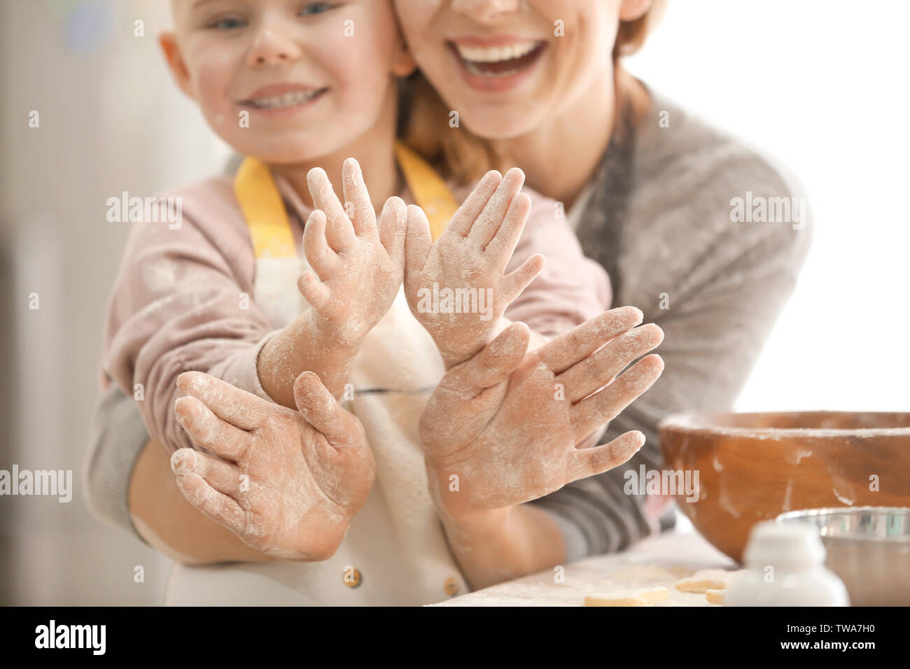 Mother and daughter having fun with flour in kitchen Stock Photo - Alamy