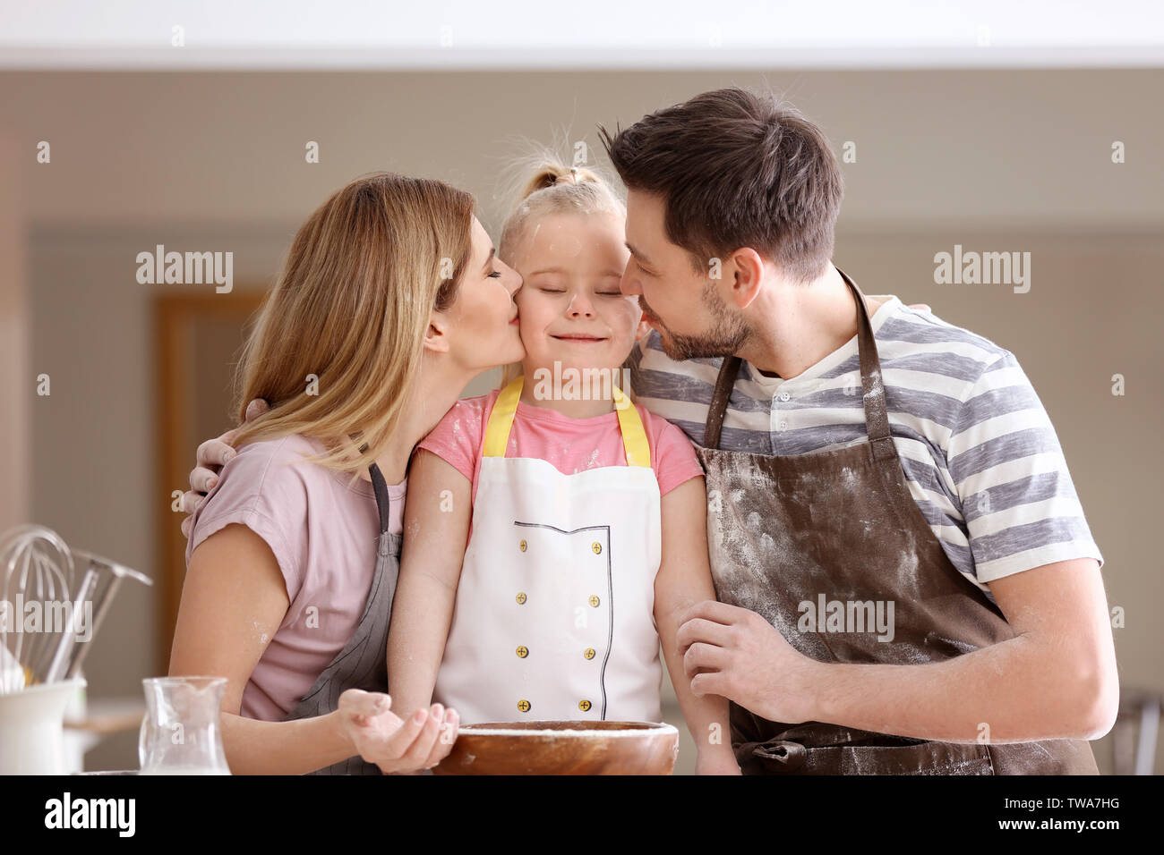 Happy family covered with flour together in kitchen Stock Photo - Alamy