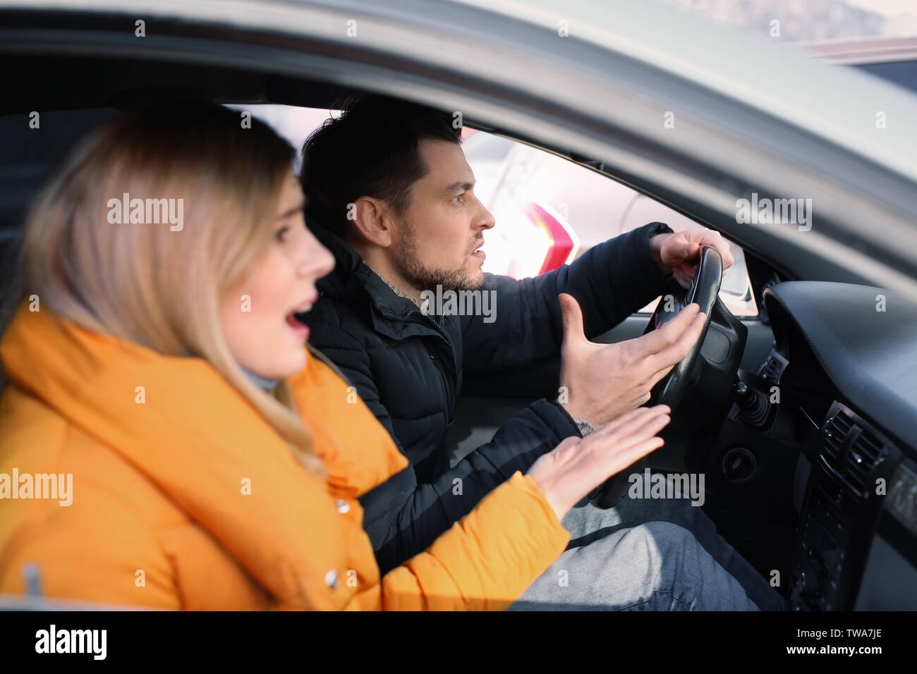 Emotional couple inside car in traffic jam Stock Photo - Alamy