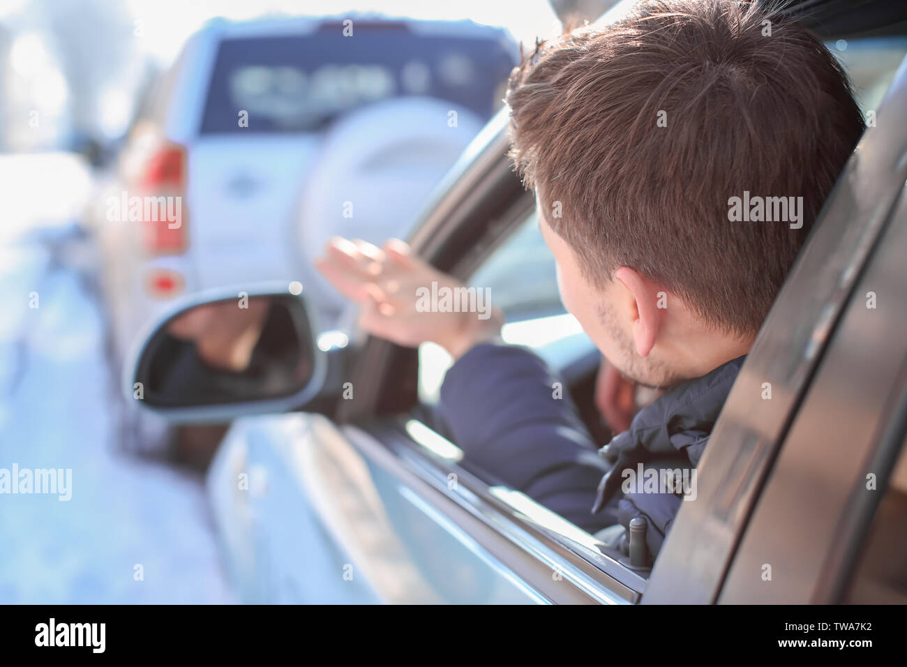 Emotional young man inside car in traffic jam Stock Photo - Alamy