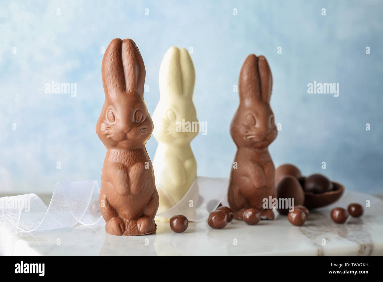 Chocolate Easter bunnies and candies on table Stock Photo - Alamy