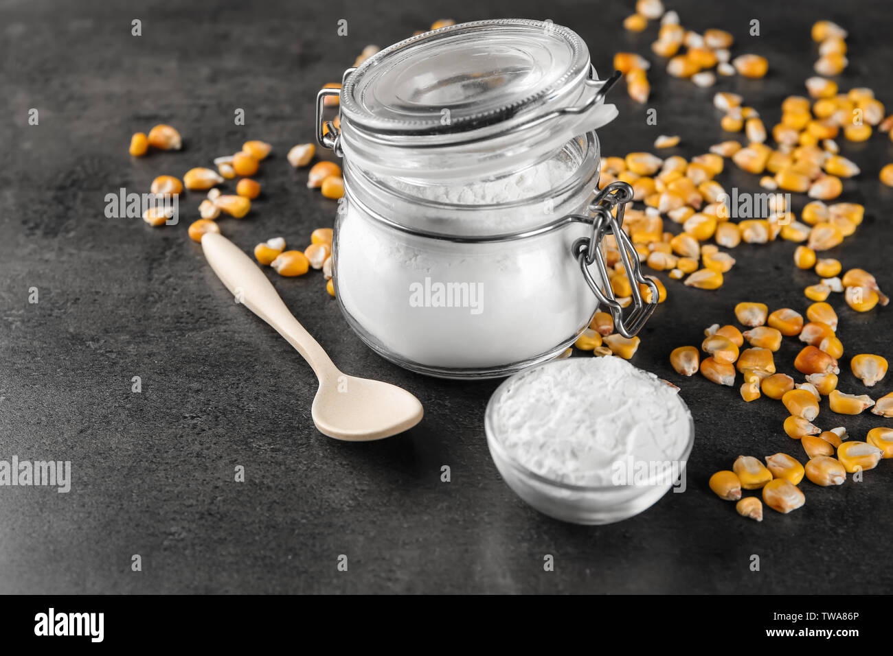 Jar and bowl with corn starch on table Stock Photo - Alamy
