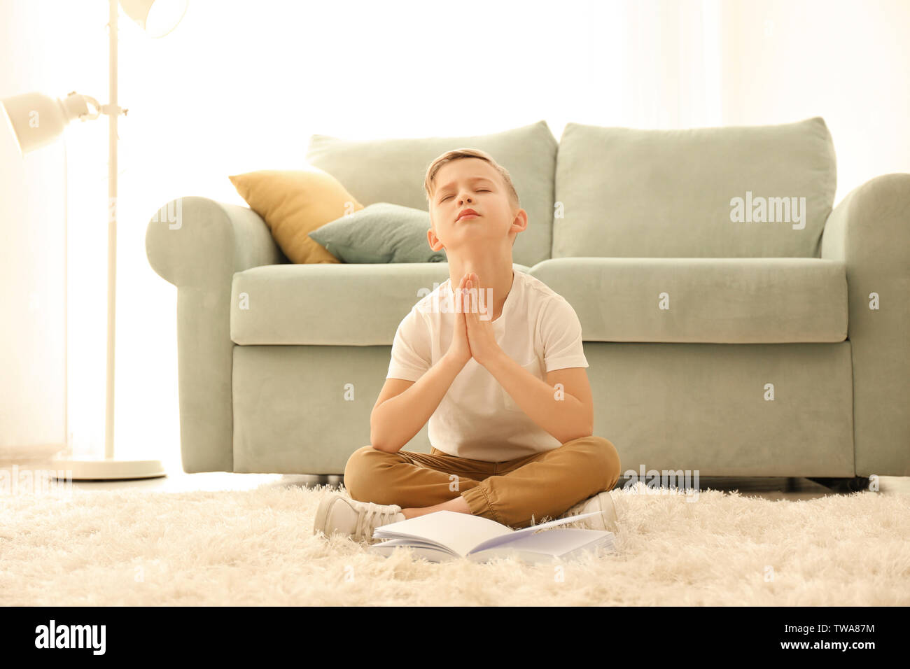 Religious little boy praying at home Stock Photo - Alamy