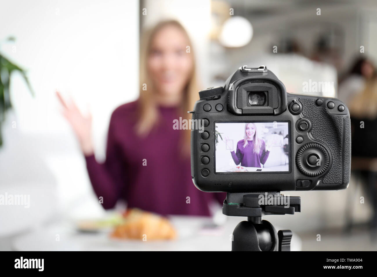 Female blogger on camera screen in cafe Stock Photo - Alamy