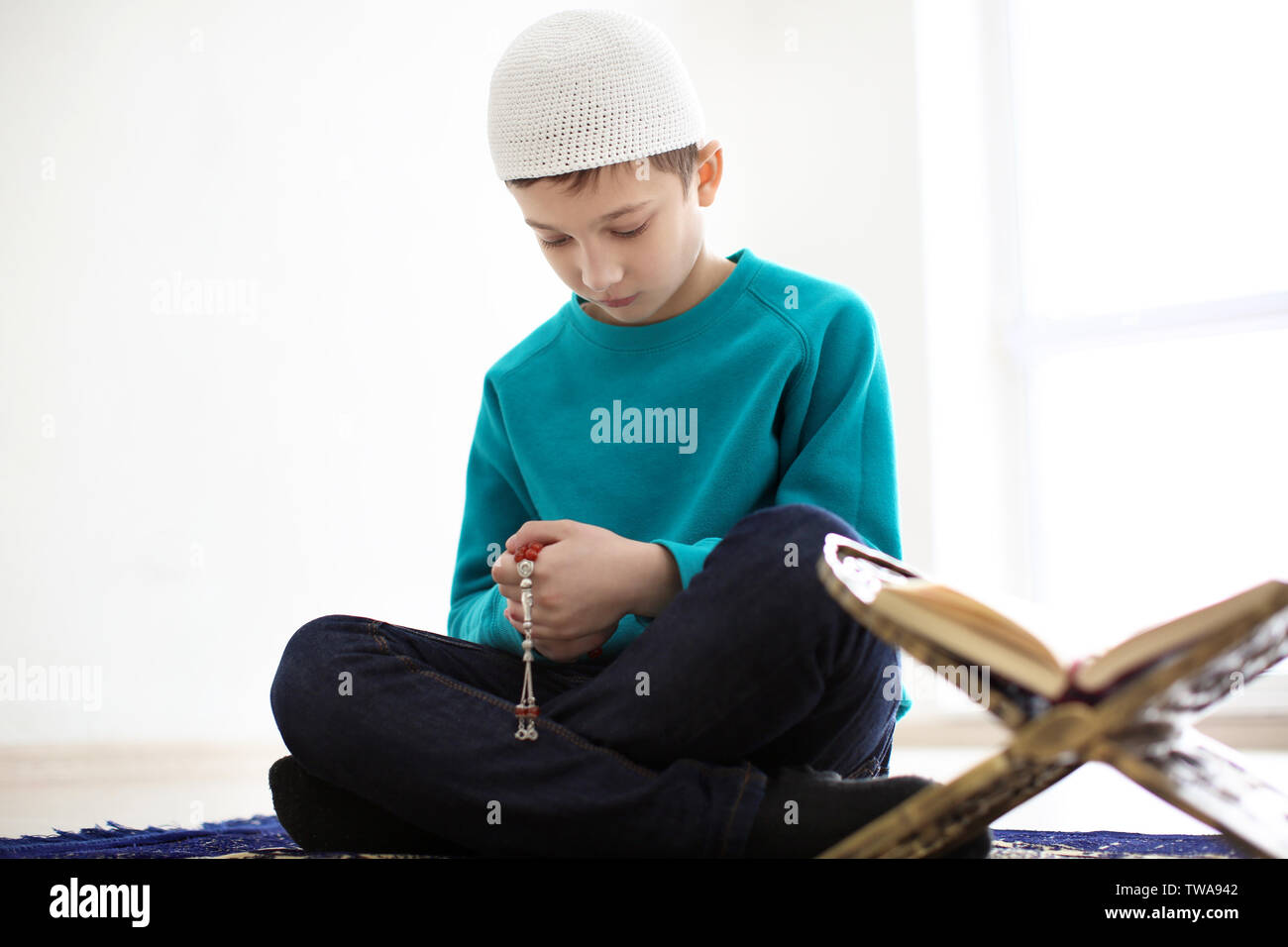 Little Muslim boy praying, indoors Stock Photo - Alamy