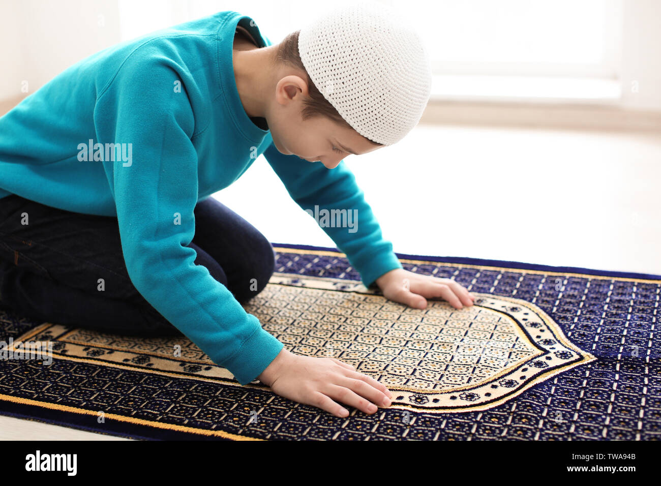 Little Muslim boy praying, indoors Stock Photo - Alamy