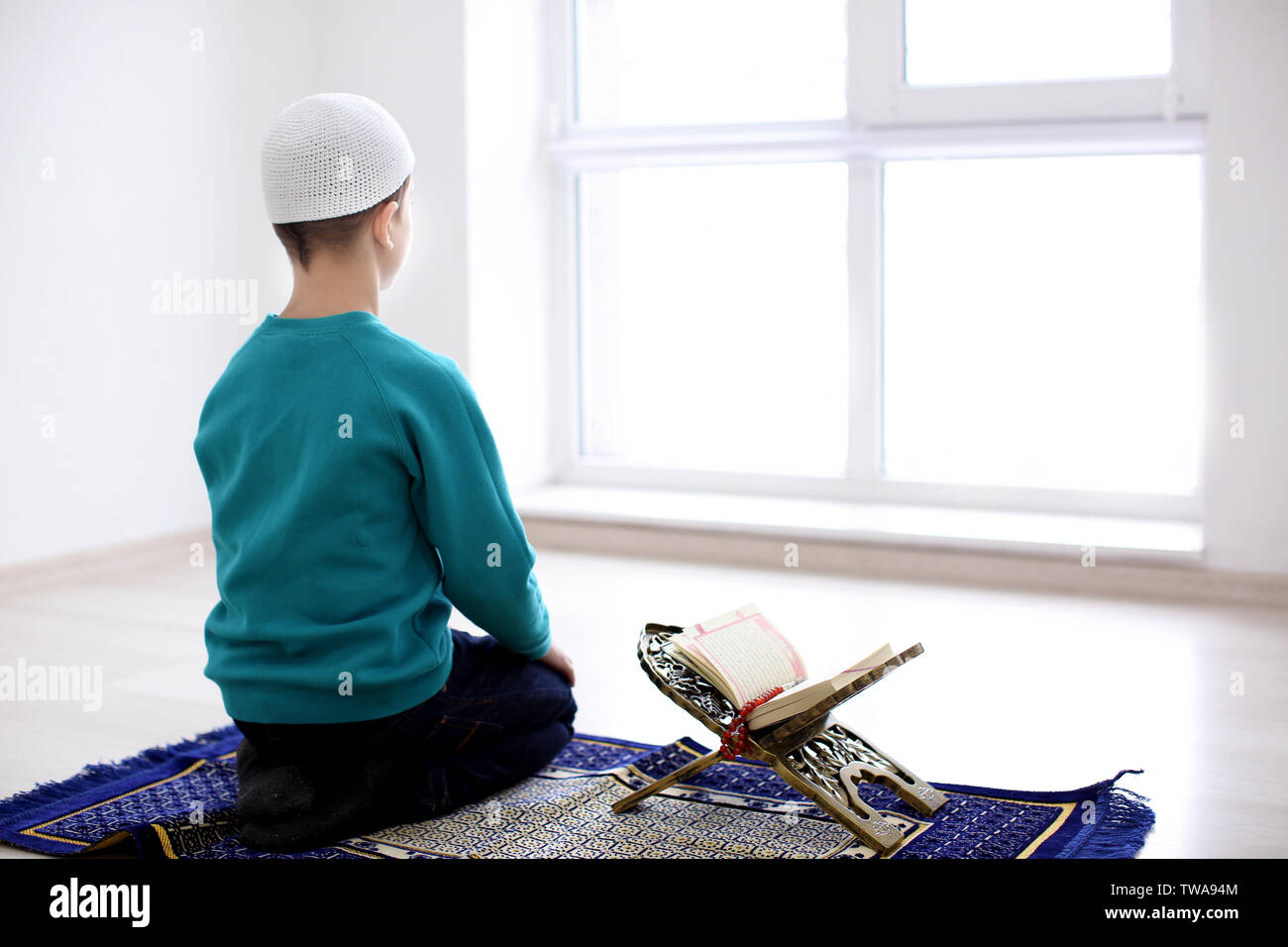 Little Muslim boy praying, indoors Stock Photo - Alamy