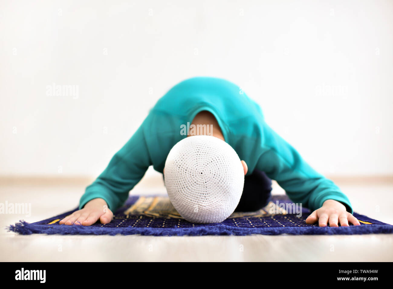 Little Muslim boy praying, indoors Stock Photo - Alamy