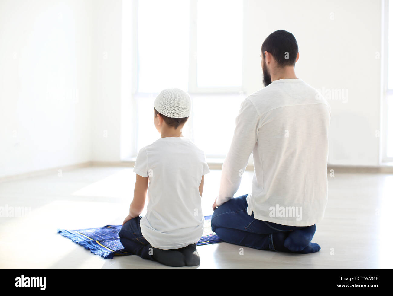 Muslim father and son praying together, indoors Stock Photo - Alamy