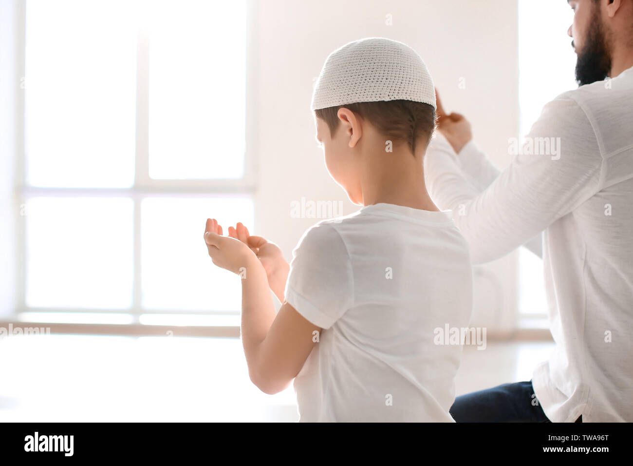 Muslim father and son praying together, indoors Stock Photo - Alamy