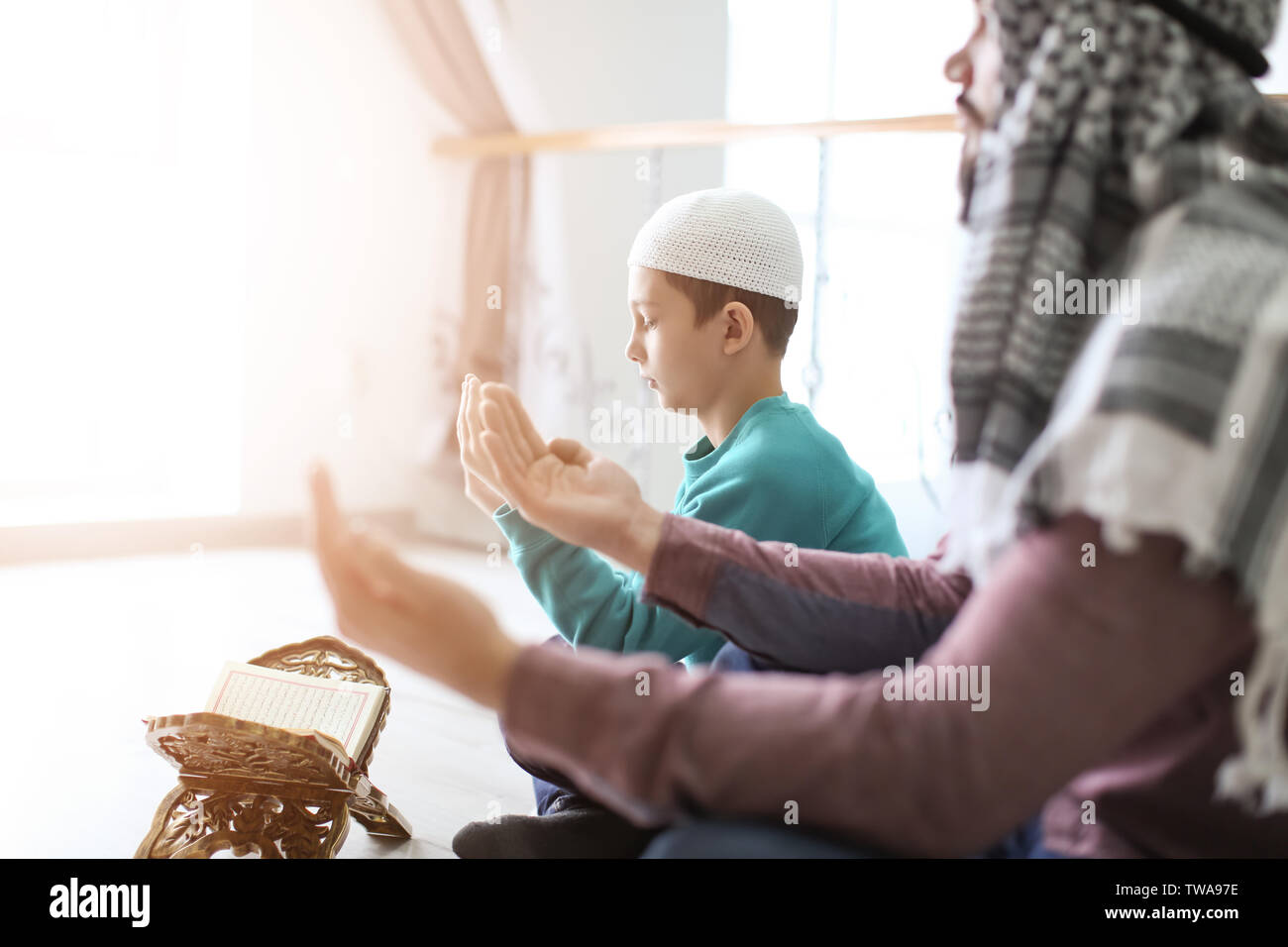 Muslim father and son praying together, indoors Stock Photo - Alamy