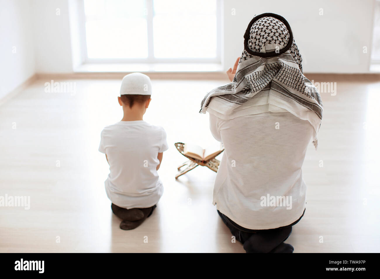 Muslim father and son praying together, indoors Stock Photo - Alamy