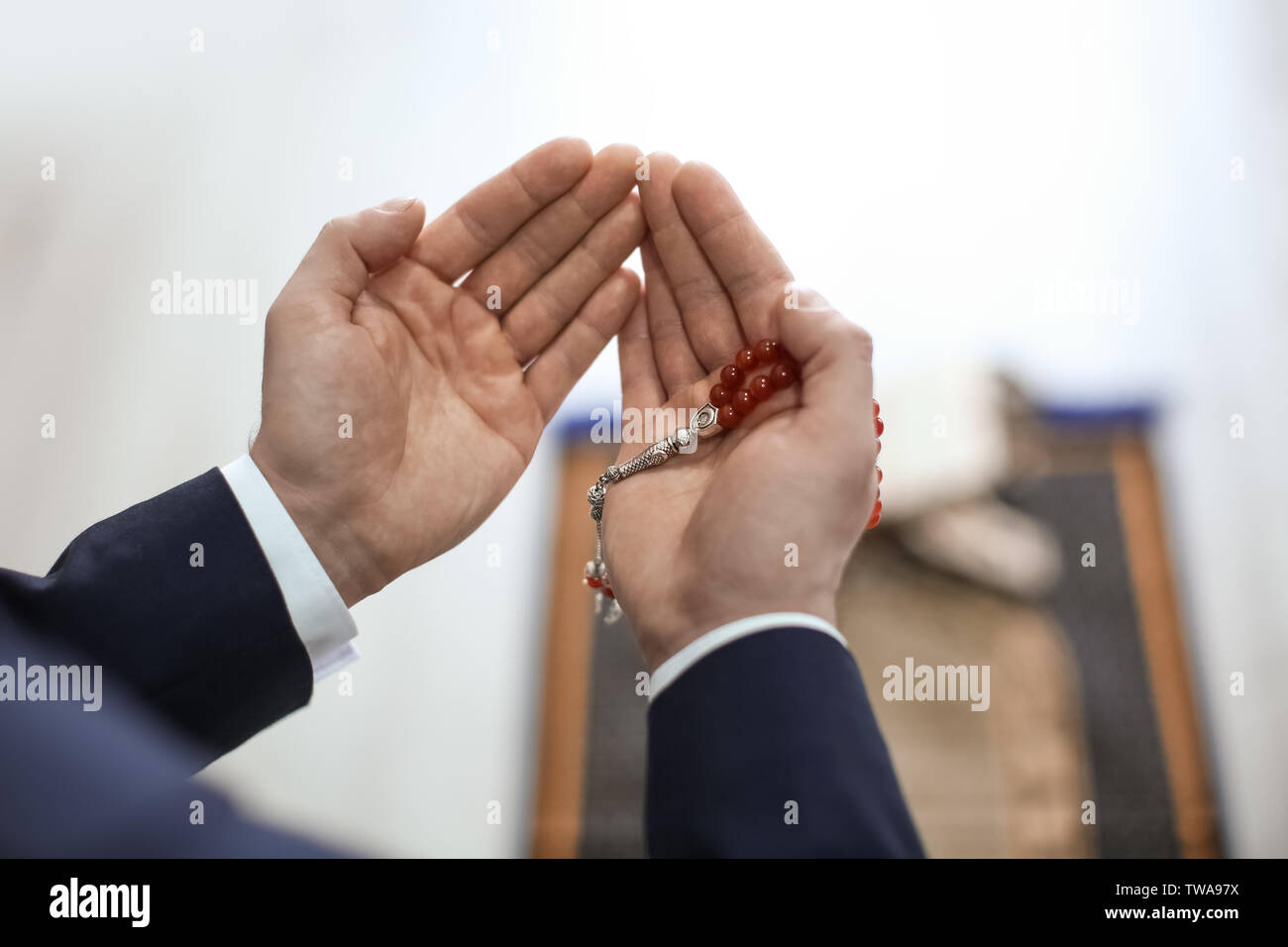 Young Muslim man praying, closeup Stock Photo - Alamy