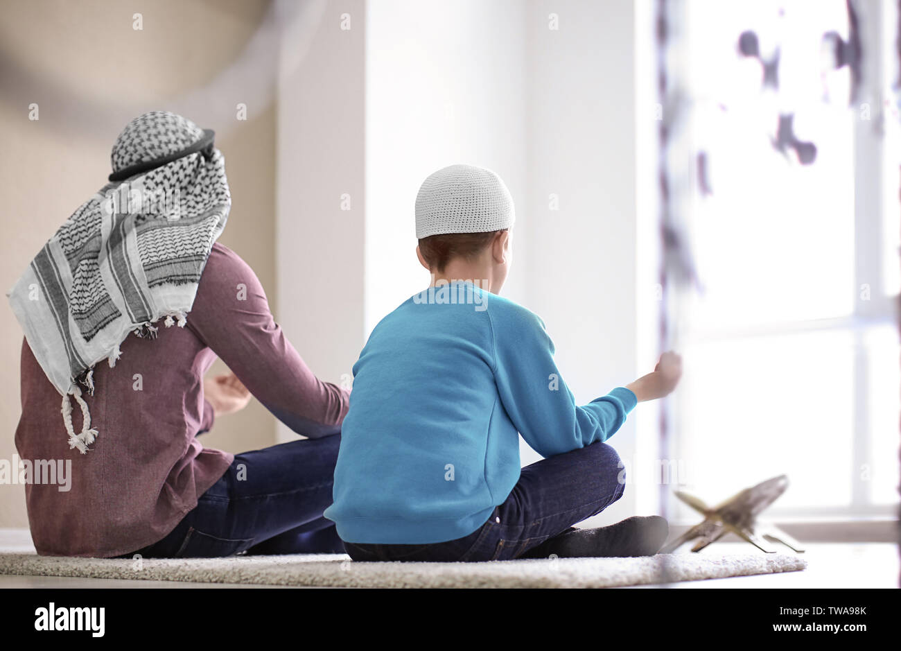 Muslim father and son praying together, indoors Stock Photo - Alamy