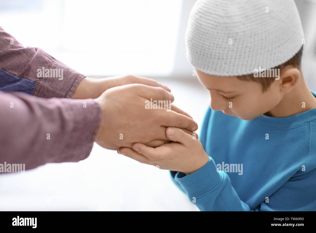 Muslim father and son praying together, indoors Stock Photo - Alamy