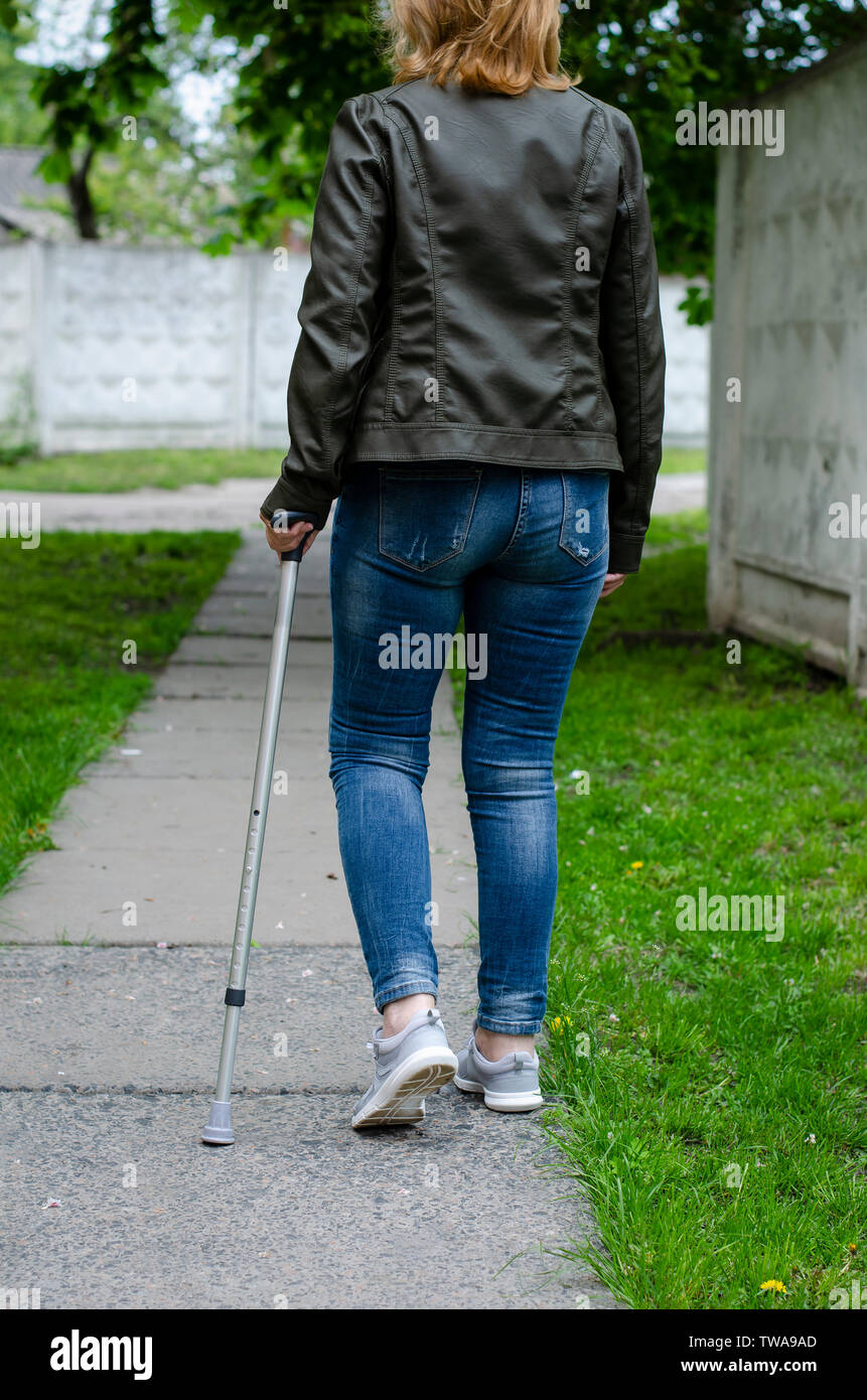 Senior woman on a rehabilitation after surgery or on recovery walks ...
