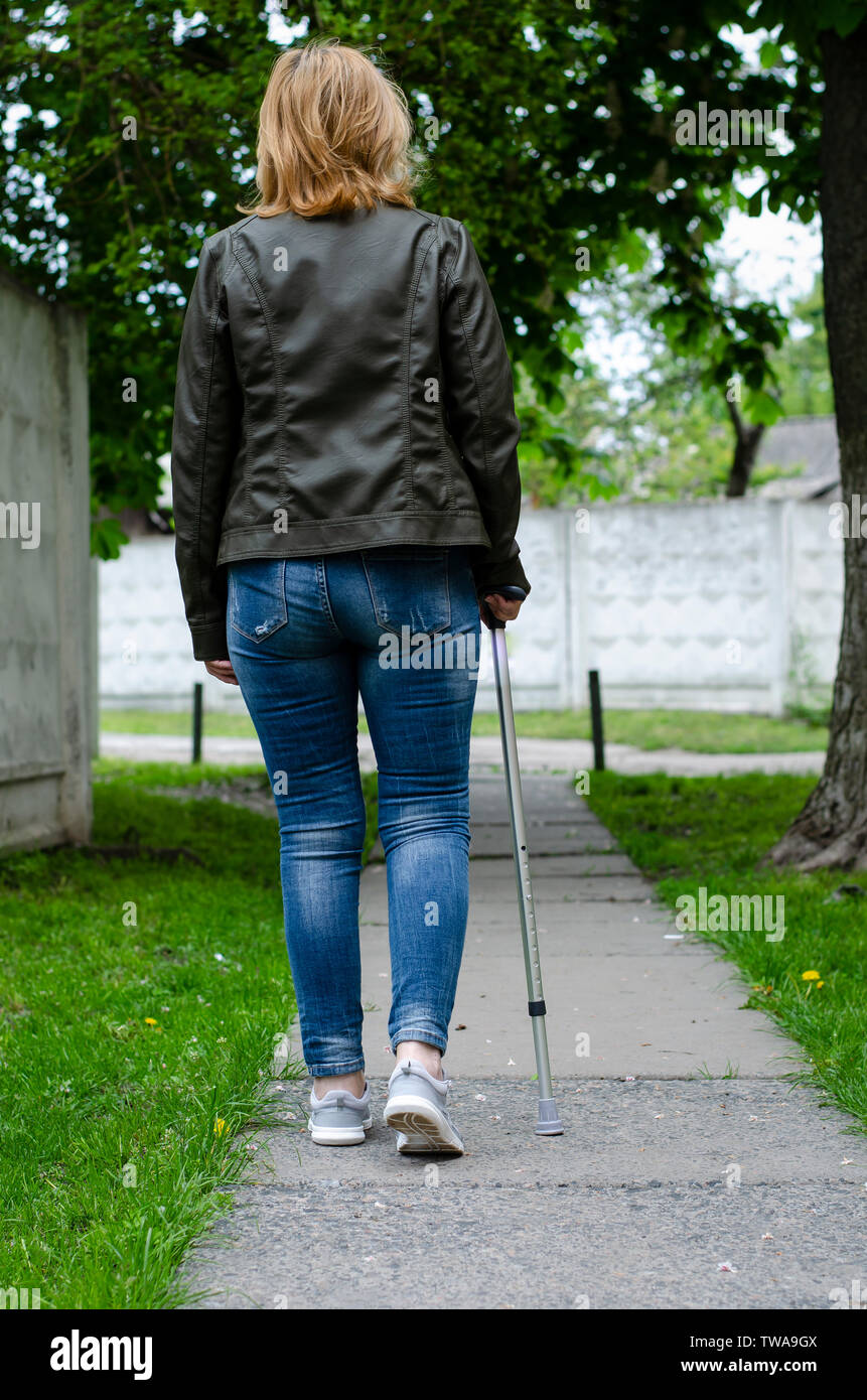 Senior woman on a rehabilitation after surgery or on recovery walks ...