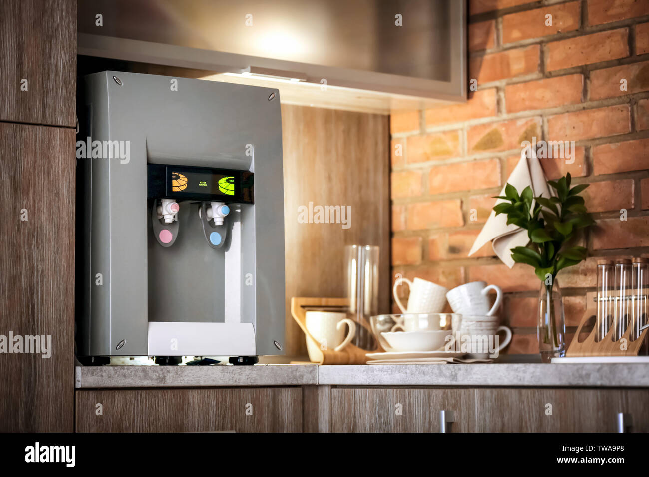 Modern water cooler on kitchen counter Stock Photo - Alamy