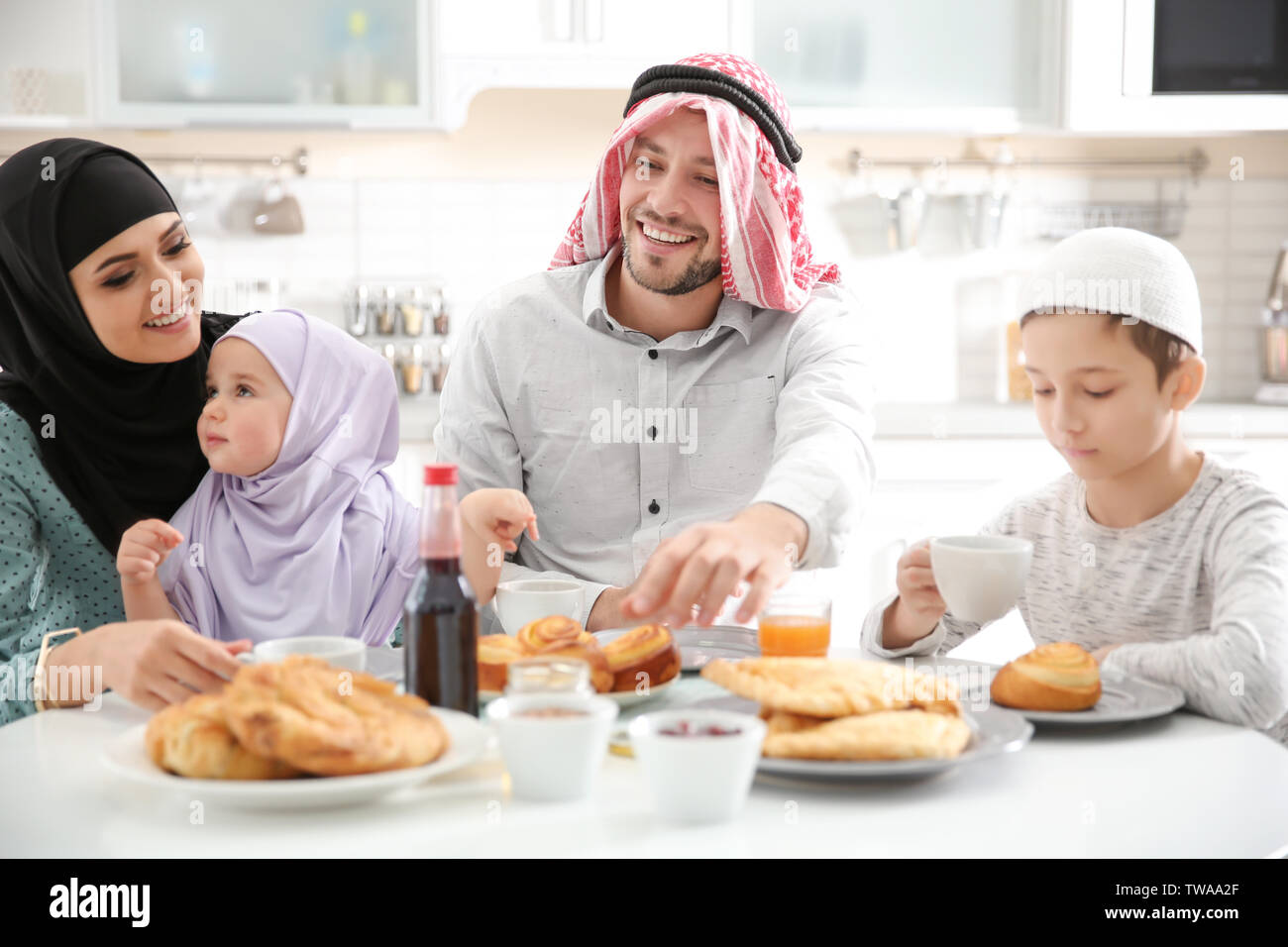 Muslim family having breakfast at home hi-res stock photography and ...