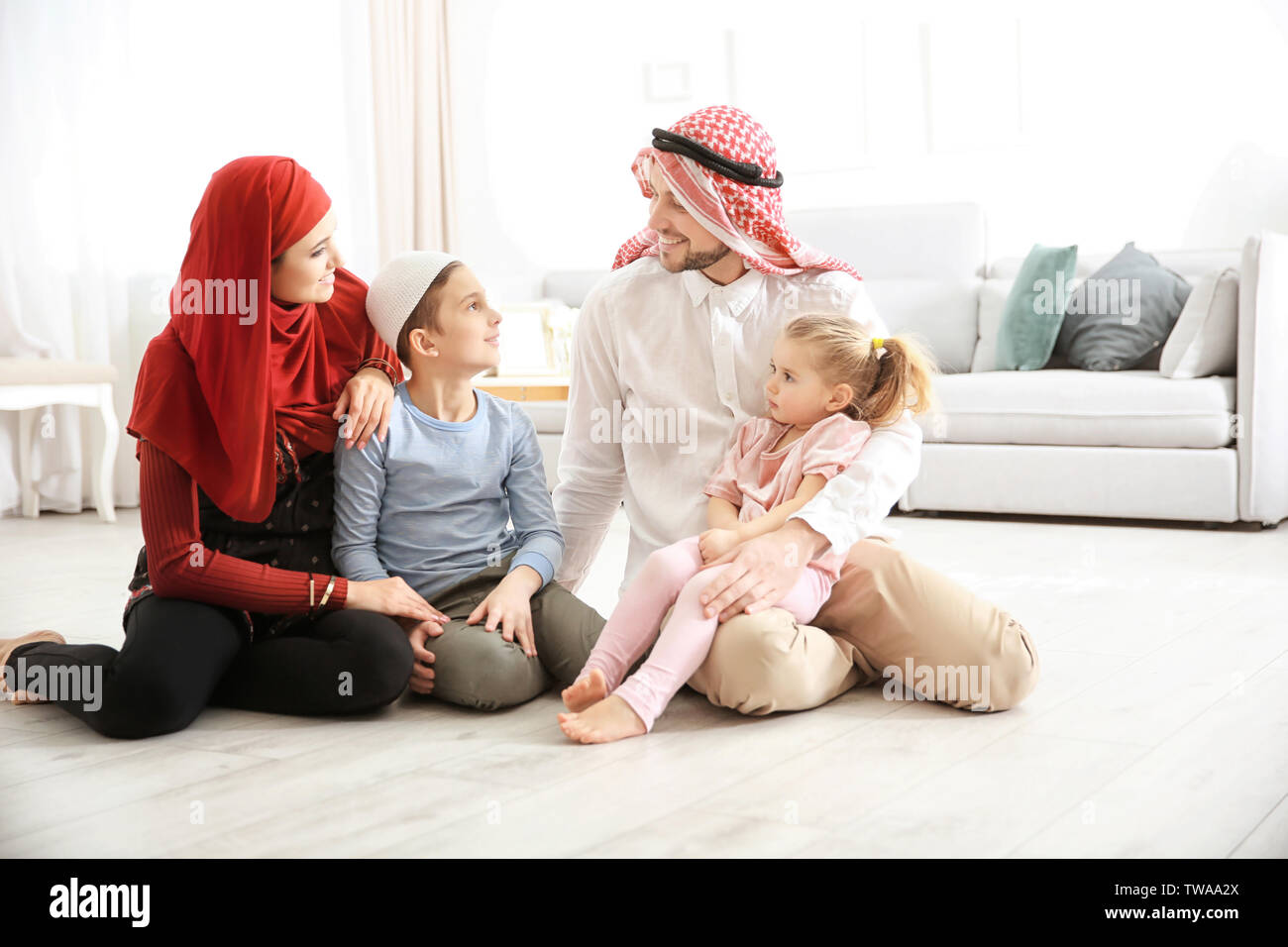 Happy Muslim family at home Stock Photo - Alamy