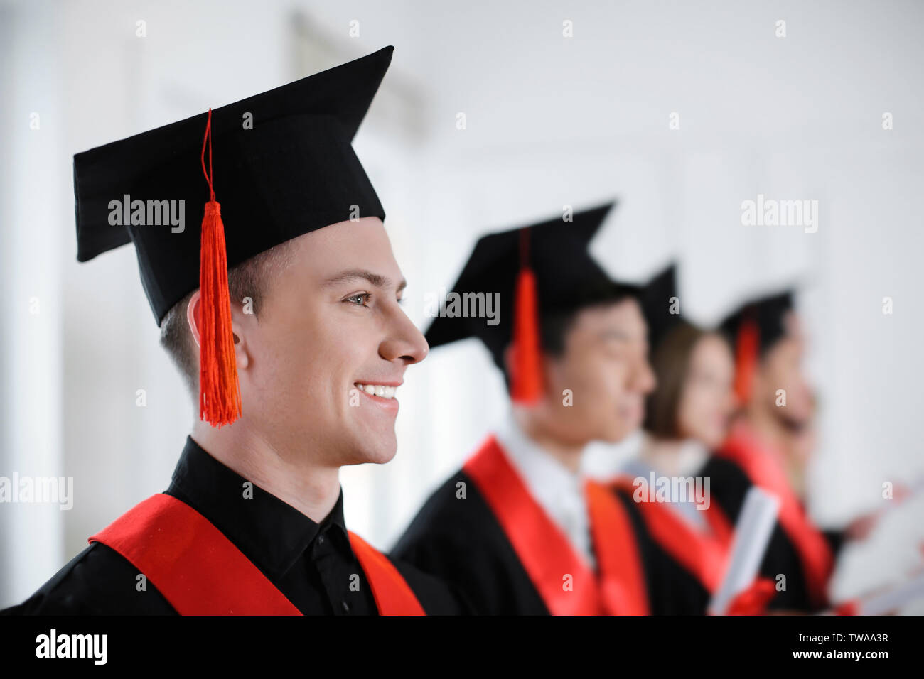 Student in bachelor robe indoors. Graduation day Stock Photo - Alamy