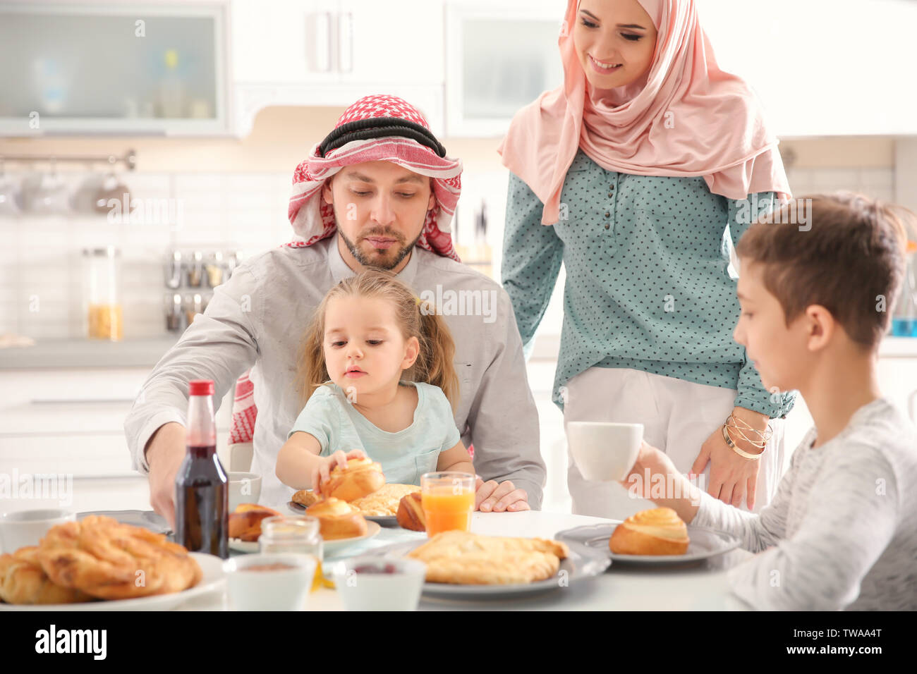 Happy Muslim family having breakfast together at home Stock Photo - Alamy