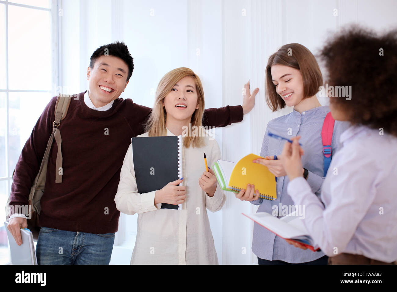 Group of students in university hall during break Stock Photo - Alamy