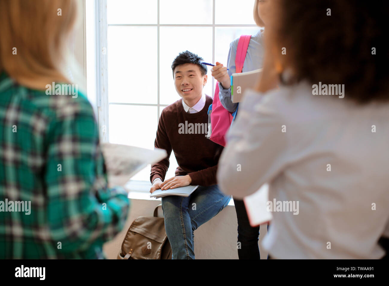 Group of students in university hall during break Stock Photo - Alamy