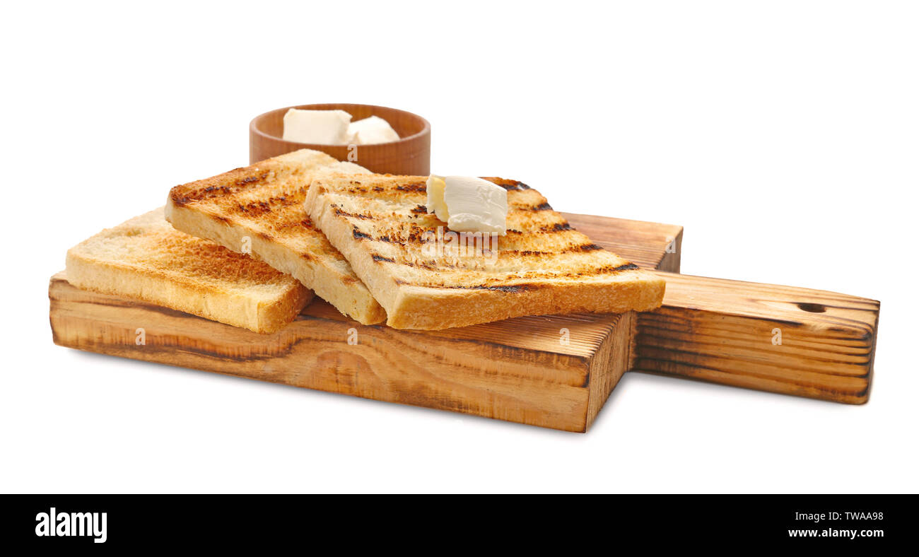 Wooden board with toasted bread and butter on white background Stock ...