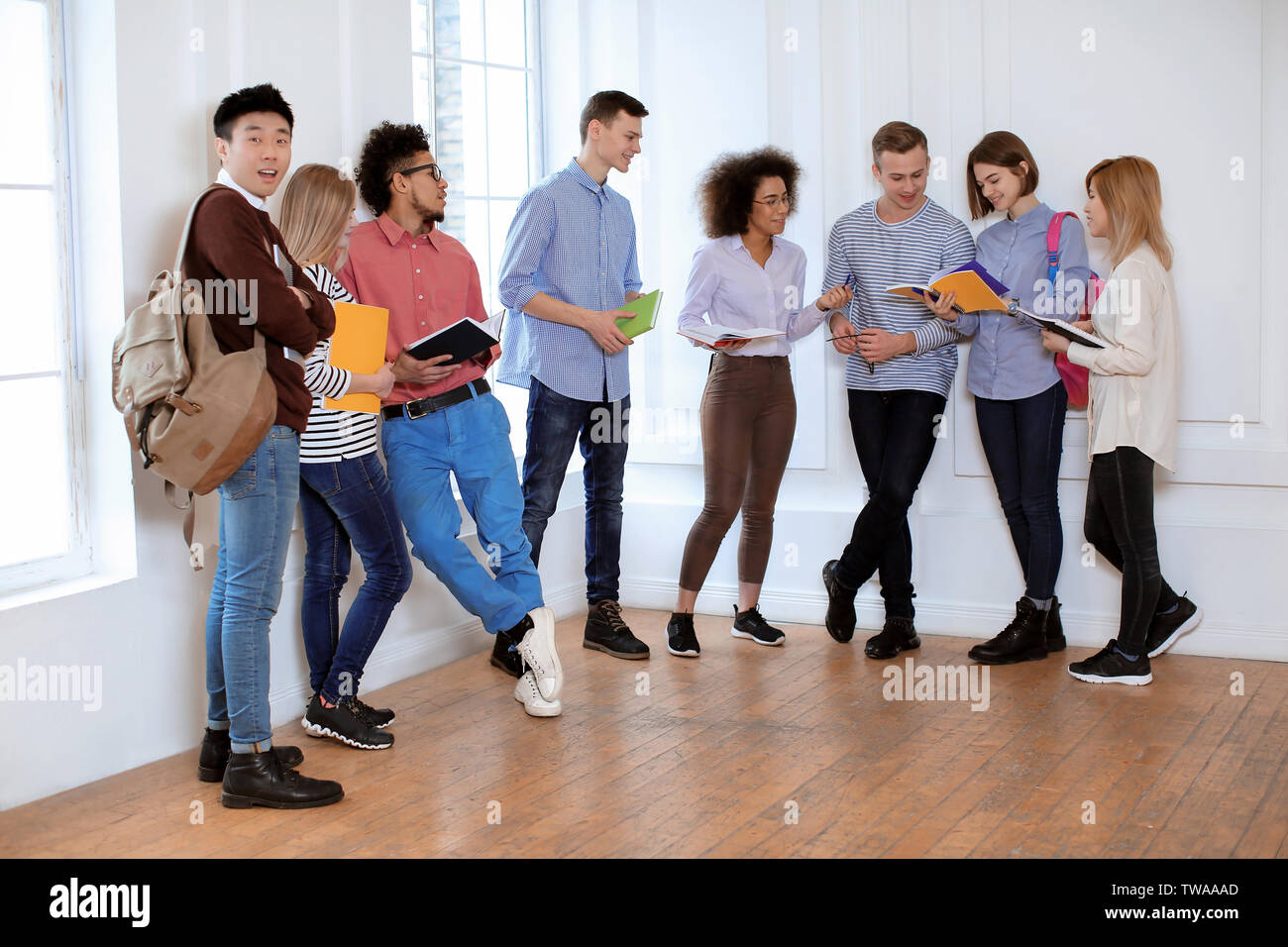 Group of students in university hall during break Stock Photo - Alamy