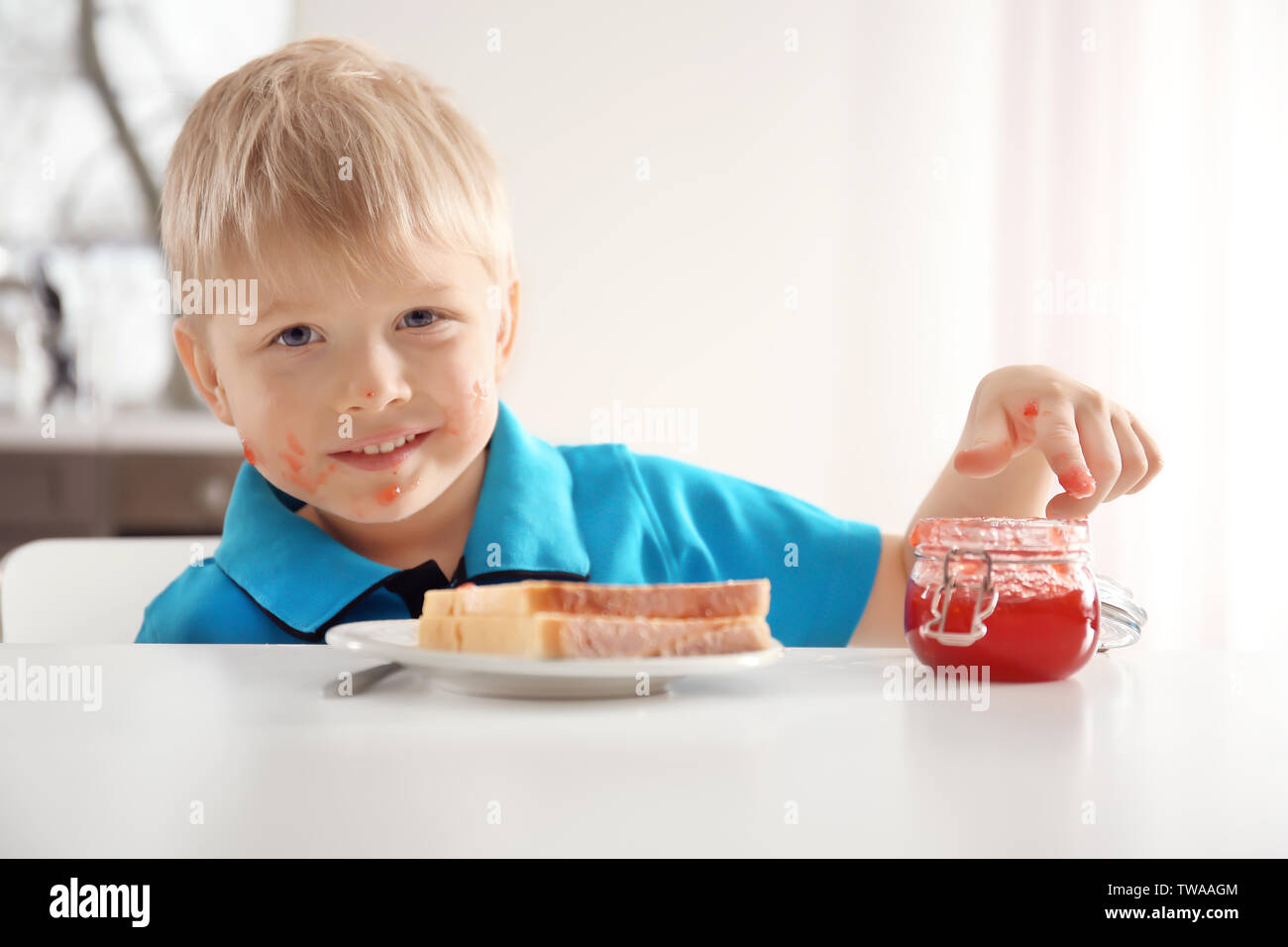 Cute little boy with jar of jam at home Stock Photo - Alamy
